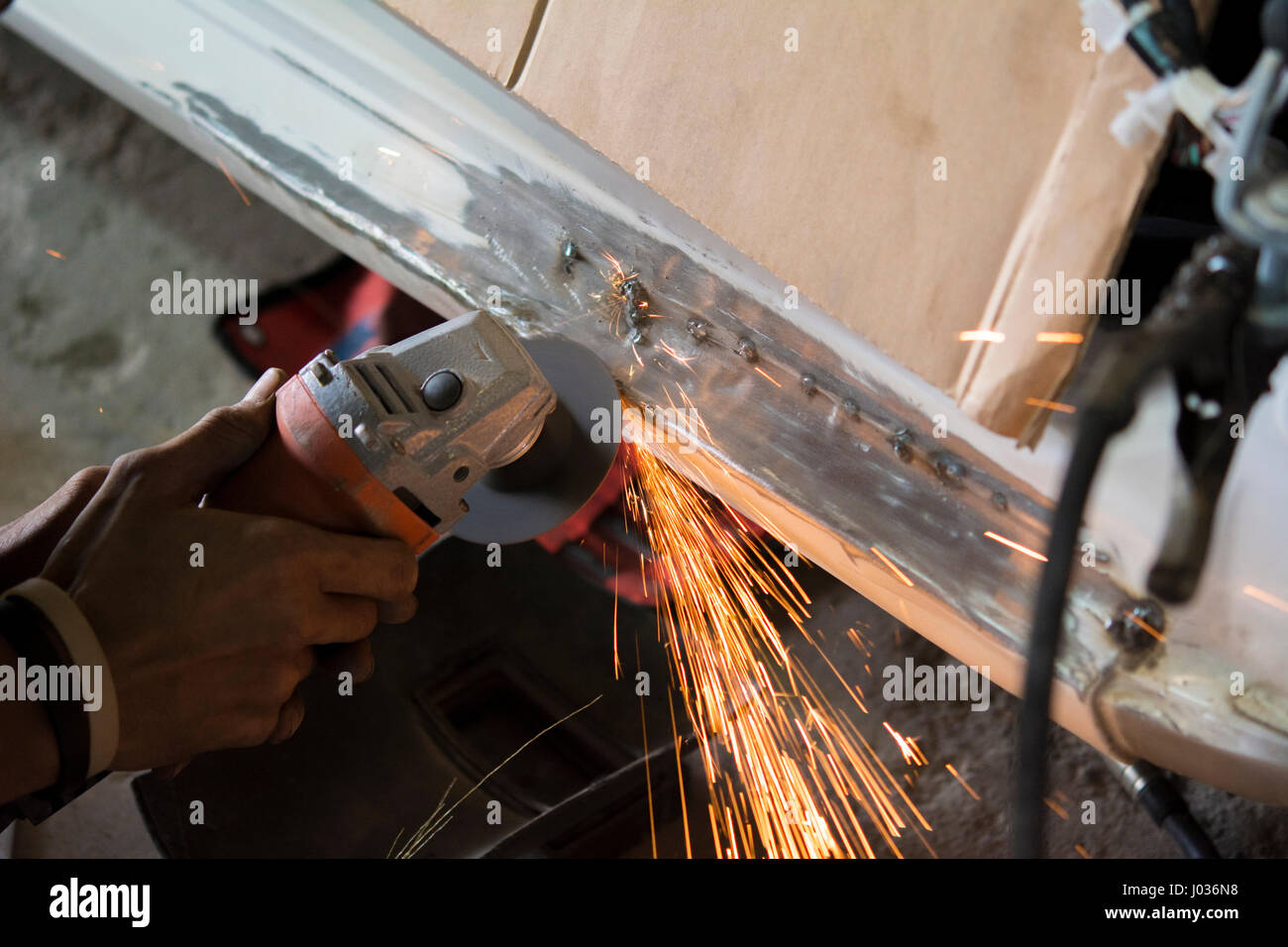 Mechanic grinding car body by grinder - auto body repair Stock Photo ...