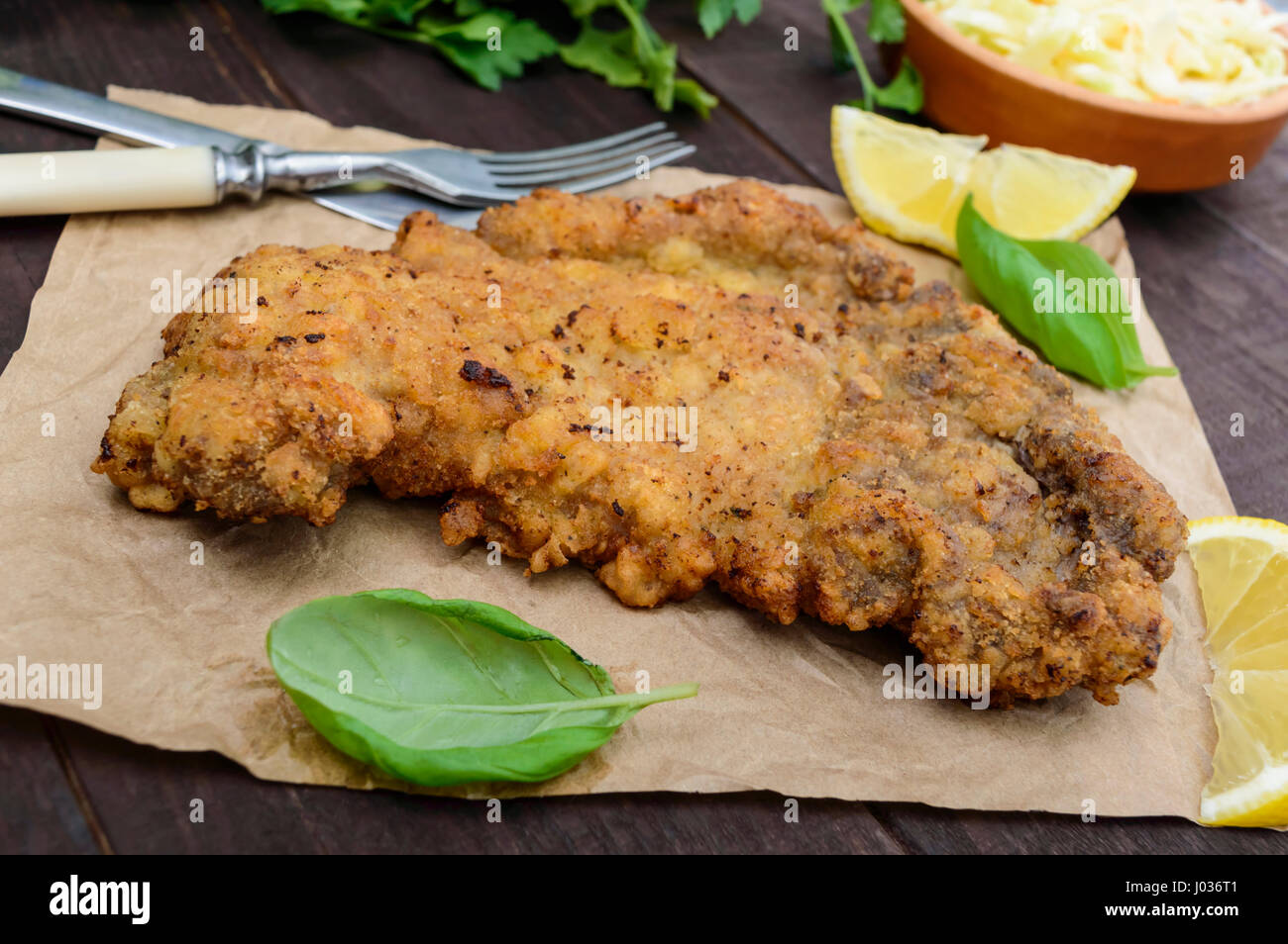 Homemade "Vienna" schnitzel on the wooden background. A traditional ...
