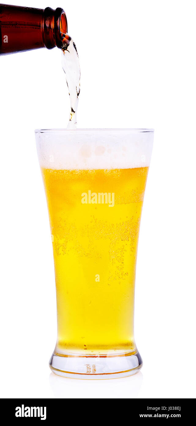 Beer into glass isolated on white background Stock Photo - Alamy