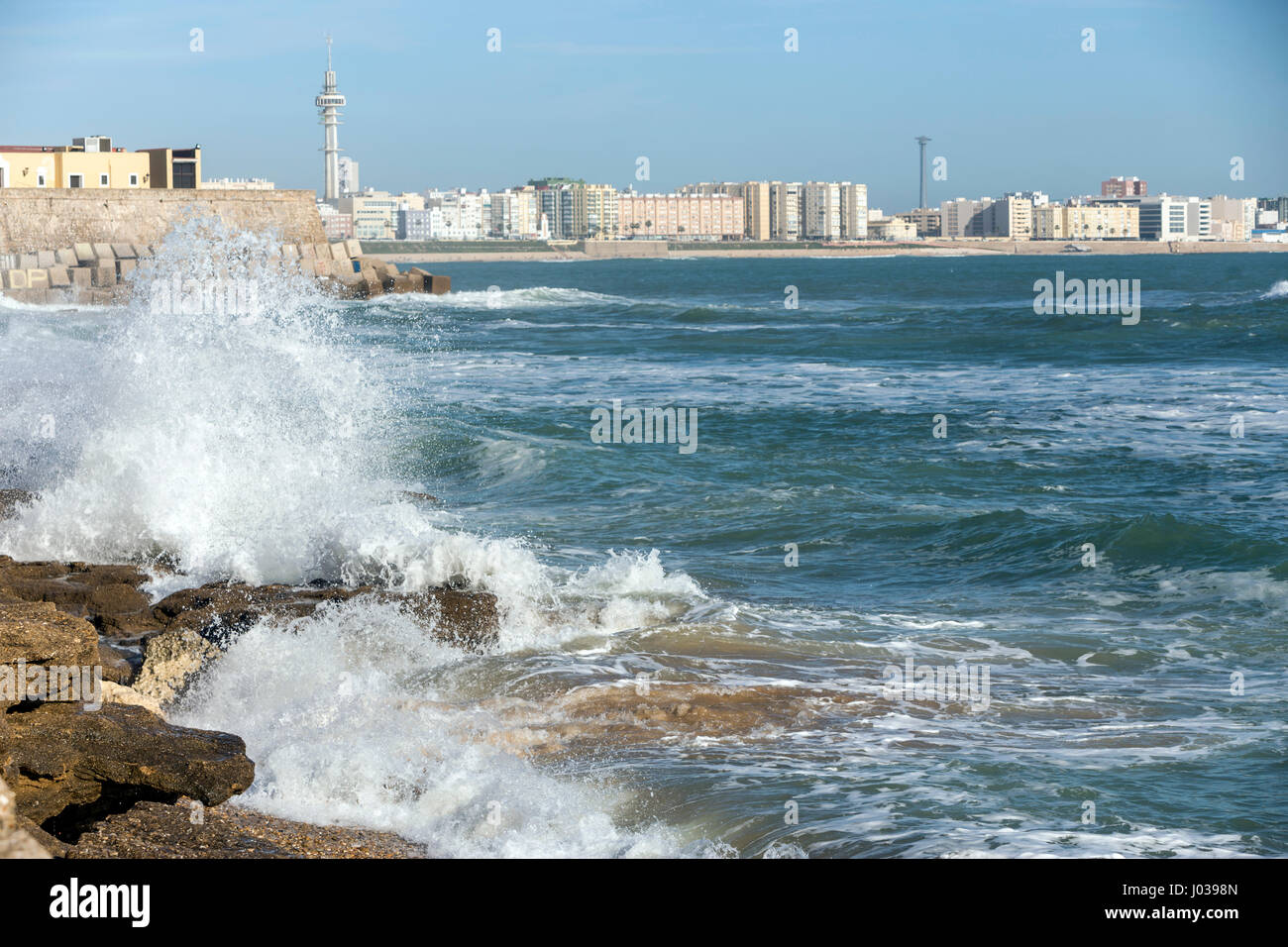 Waves hit the rocks on the promenade of the La Caleta beach in Cadiz ...