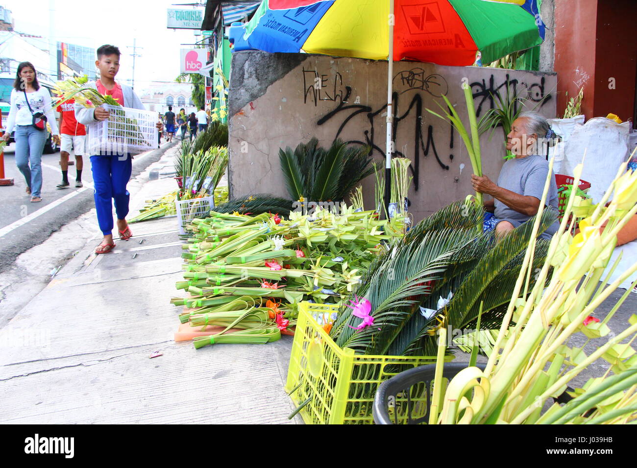 A palm leaves vendor (palaspas) selling his craft in Oliveros Street ...