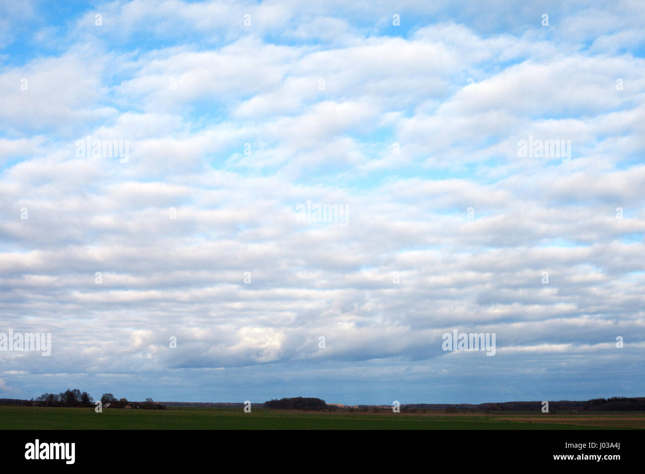Blue sky over land Stock Photo - Alamy