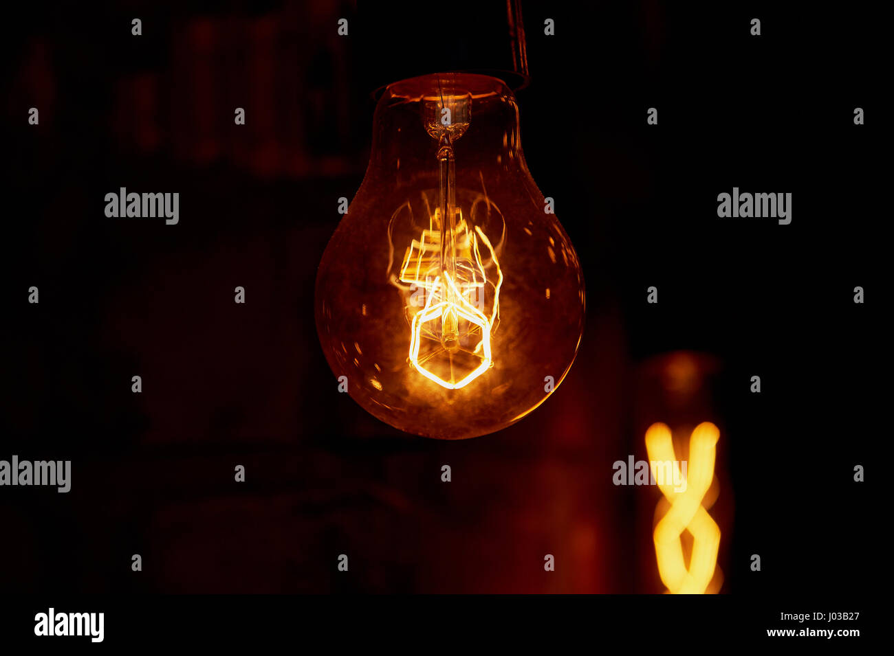 Edison light bulb hanging on a long wire. Cozy warm yellow light.Retro ...