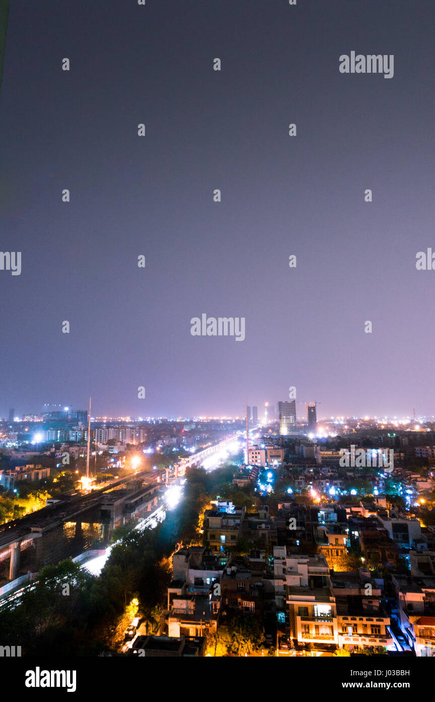Noida cityscape at night with houses, office, skyscrapers, streets and ...