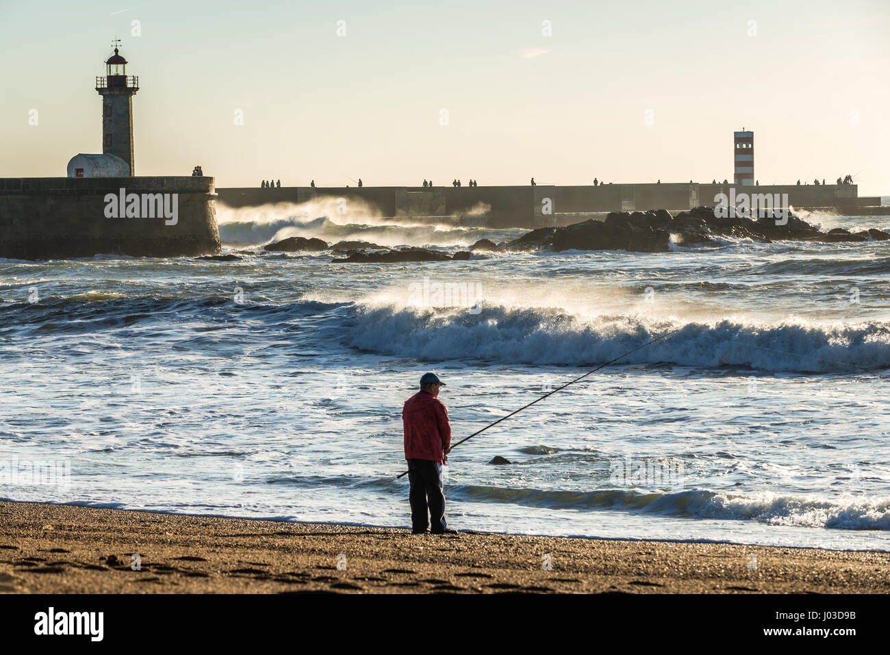 Man fishing from the beach in Foz do Douro district of Porto city ...
