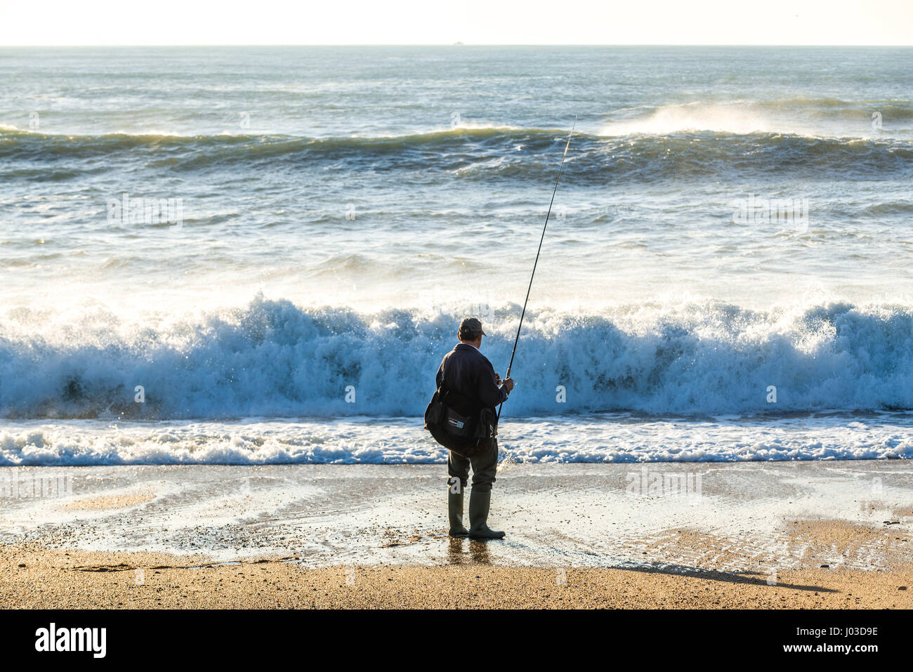 Man fishing from the beach in Foz do Douro district of Porto city ...