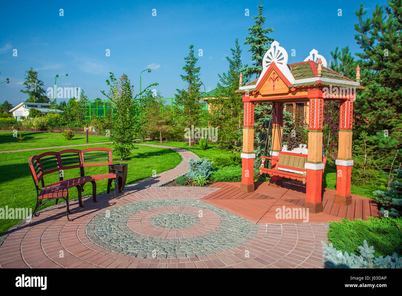 Wooden big swing in garden Stock Photo - Alamy