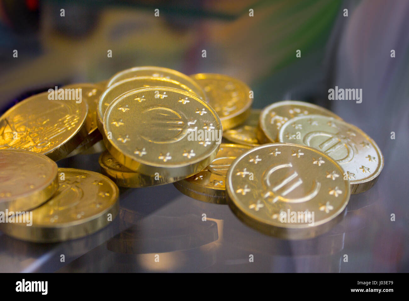 Small chocolates wrapped in metallic paper Stock Photo - Alamy