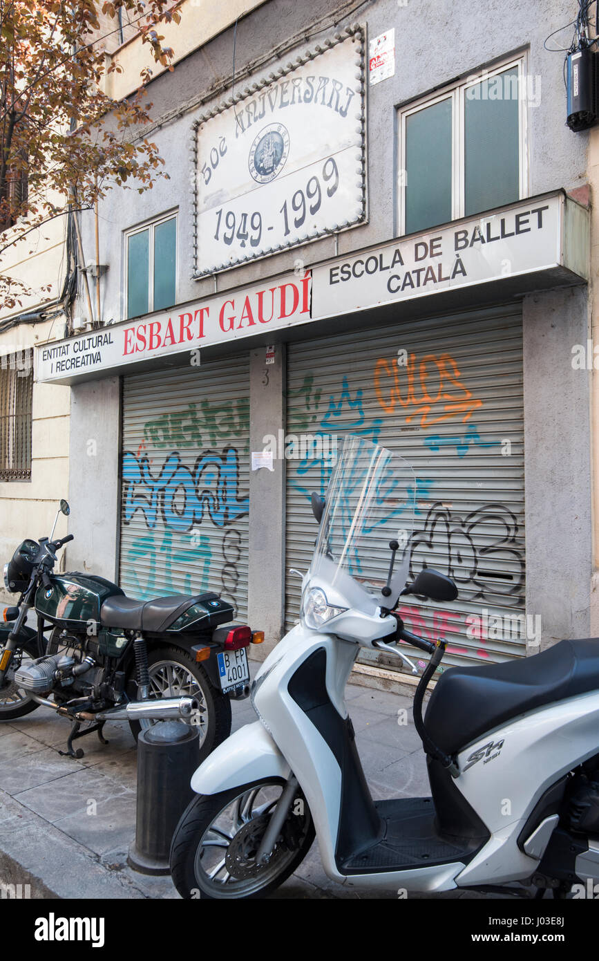 Motorbikes parked outside shops on a street in Barcelona, Spain Europe ...