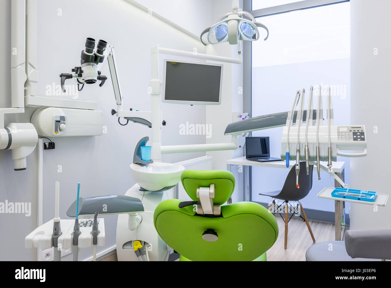 White interior with modern dental unit, screen and digital radiography ...