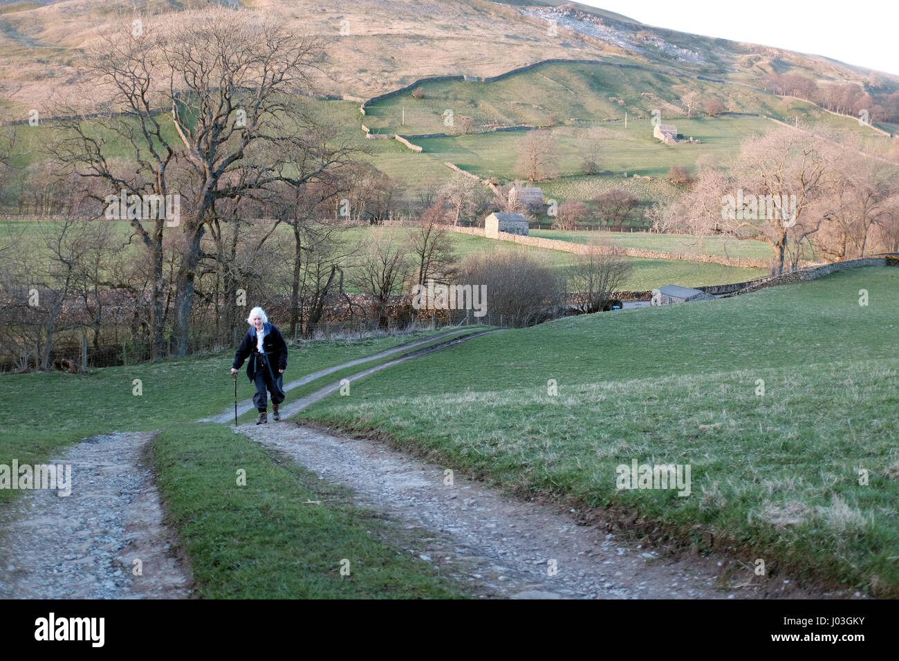 Old woman walking countryside hi-res stock photography and images - Alamy