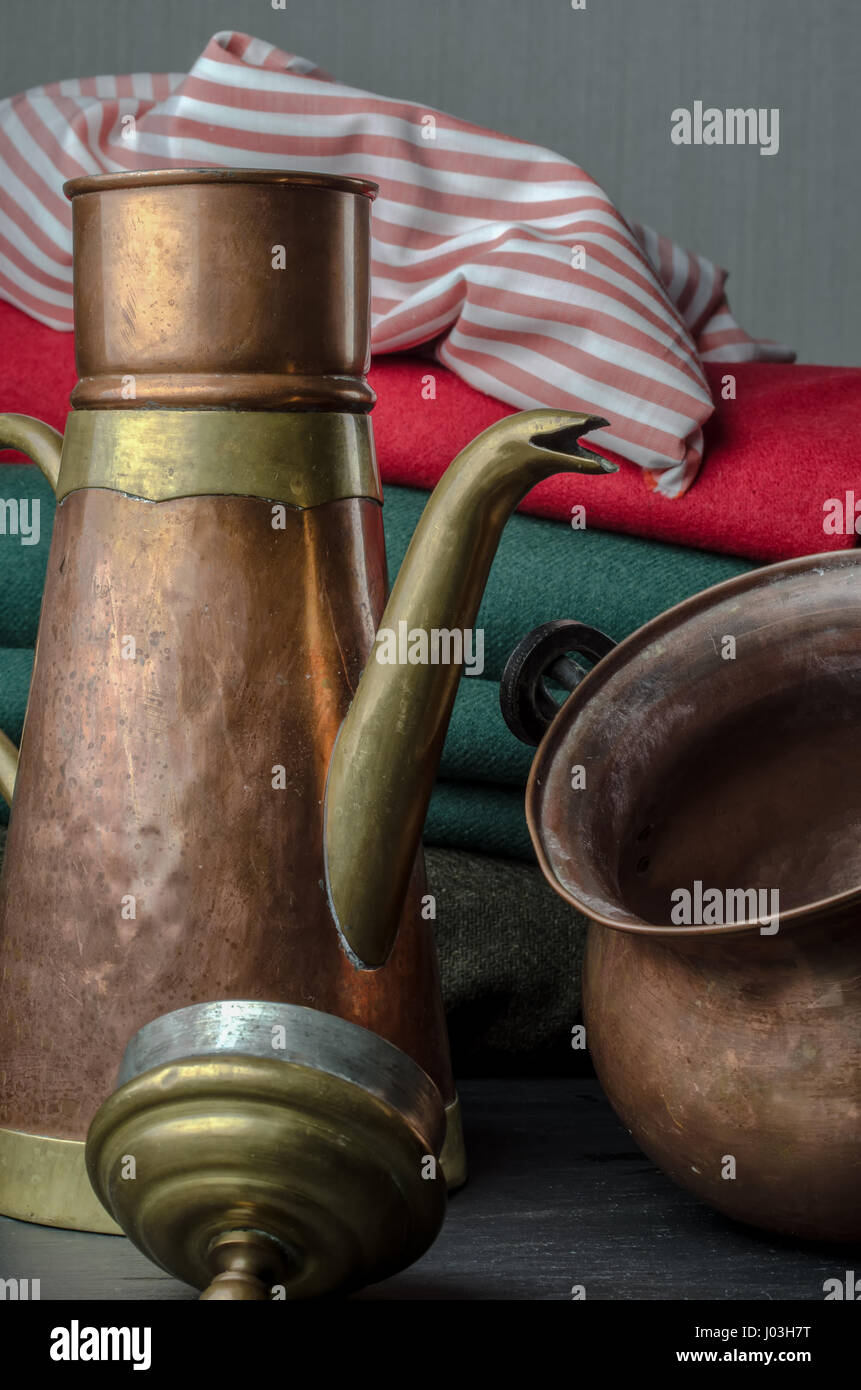 Empty bronze and copper tea cattle and pot with different color cloth ...