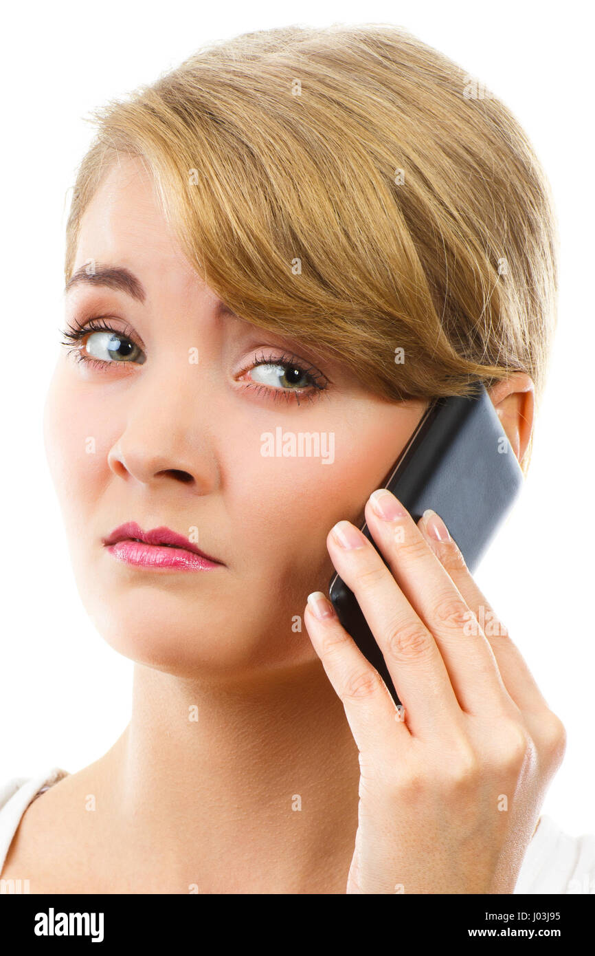 Unhappy worried sad woman talking on mobile phone and informing someone ...