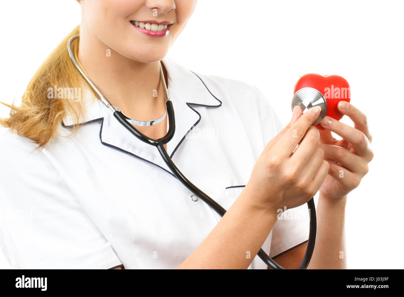Woman doctor cardiologist in white apron with stethoscope examining red ...