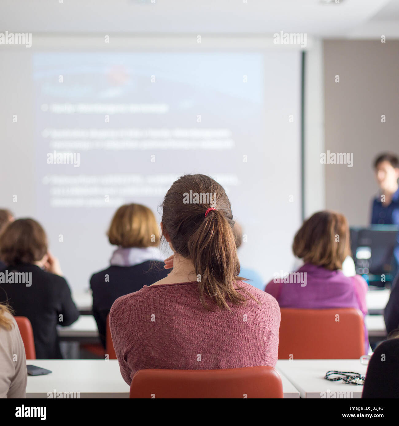 Woman giving presentation in lecture hall at university Stock Photo - Alamy