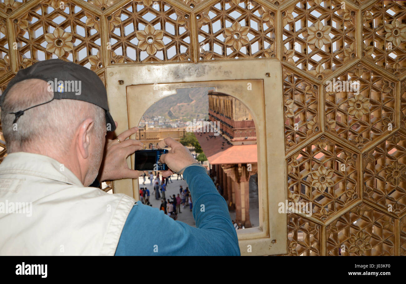Tourist looking out through window at amber fort Stock Photo - Alamy