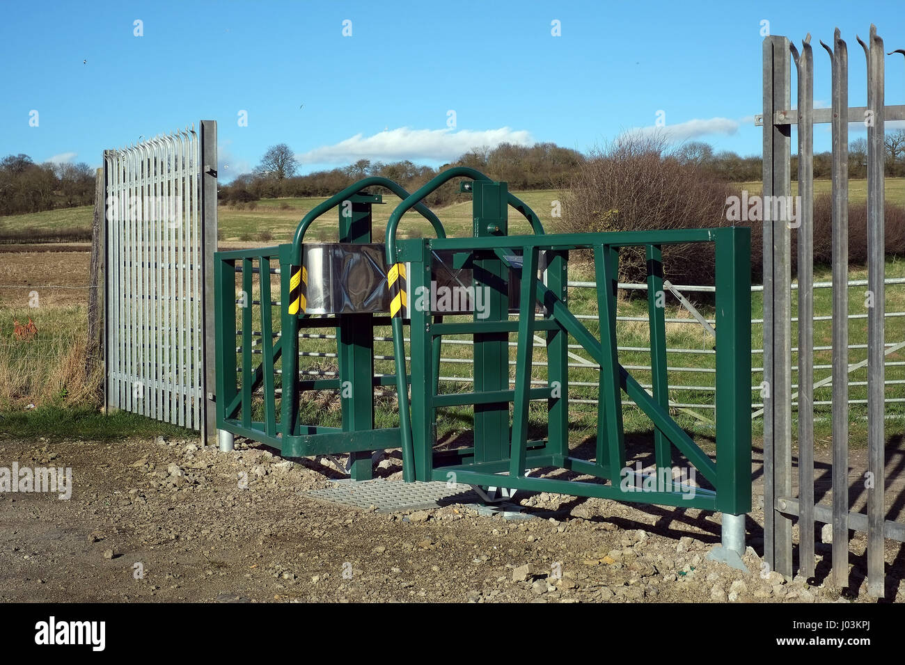 Modern access restriction steel safety gate on country path to prevent ...