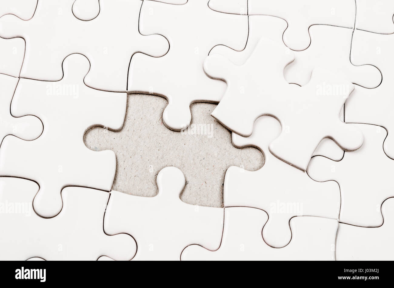 Plain white jigsaw puzzle Stock Photo - Alamy