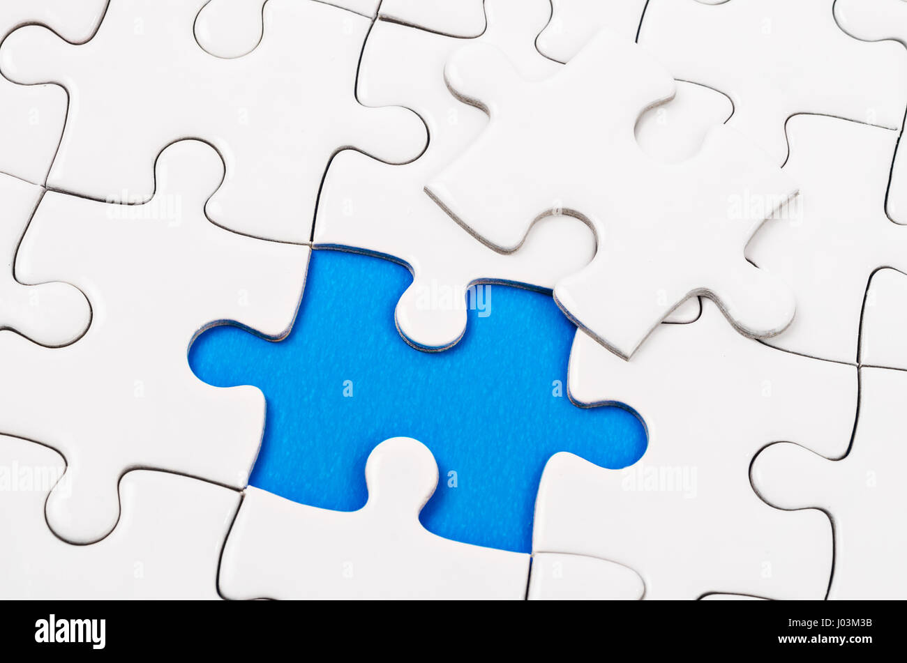 Plain white jigsaw puzzle, on blue background Stock Photo - Alamy