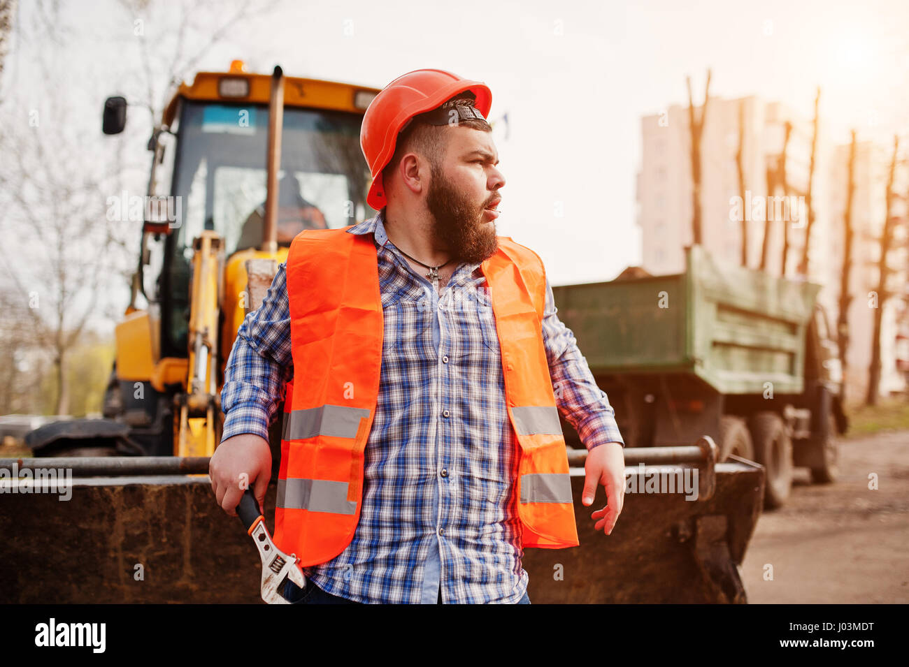 Brutal beard worker man suit construction worker in safety orange ...