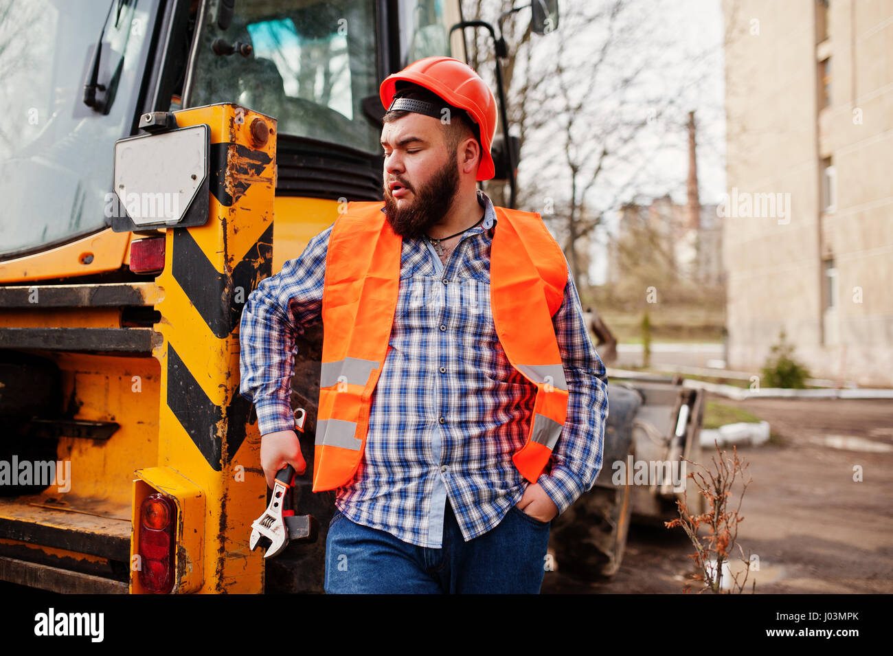 Brutal beard worker man suit construction worker in safety orange ...