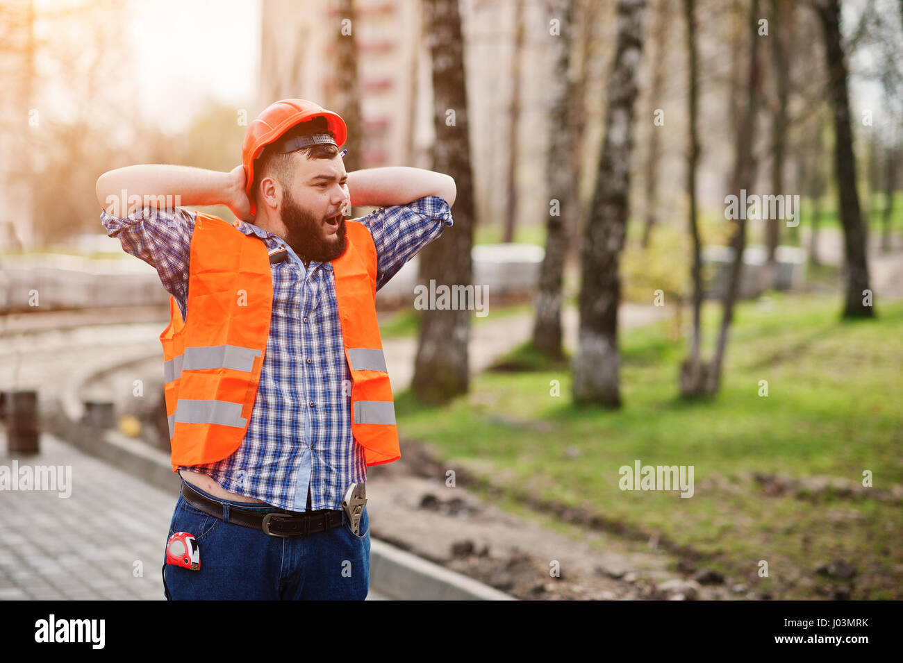 Portrait of lazy yawns brutal beard worker man suit construction worker ...