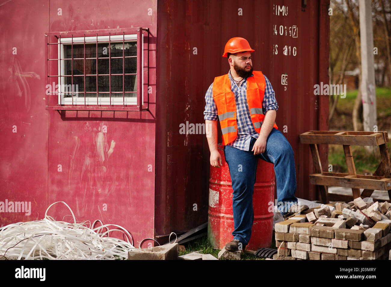 Brutal beard worker man suit construction worker in safety orange ...