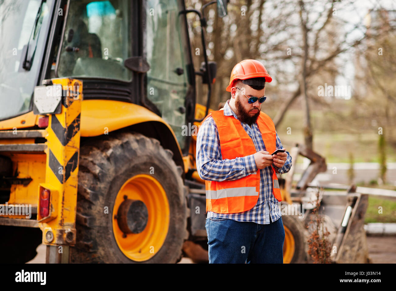 Brutal beard worker man suit construction worker in safety orange ...