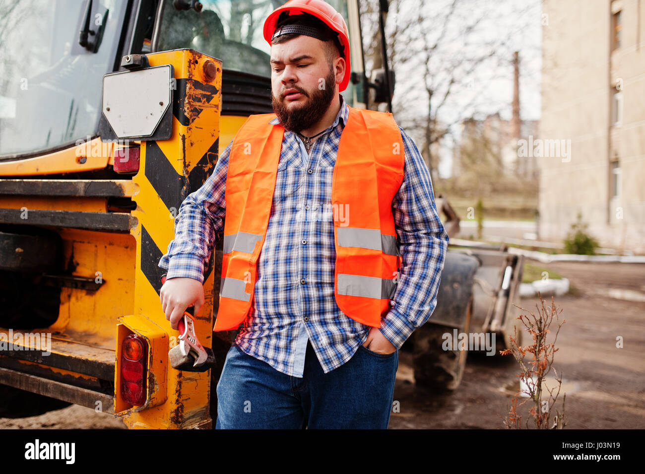 Brutal beard worker man suit construction worker in safety orange ...