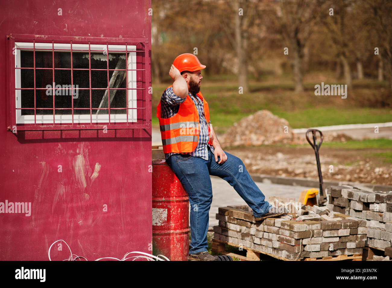 Brutal beard worker man suit construction worker in safety orange ...
