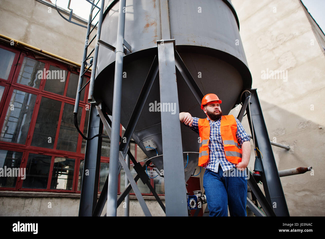 Brutal beard worker man suit construction worker in safety orange ...