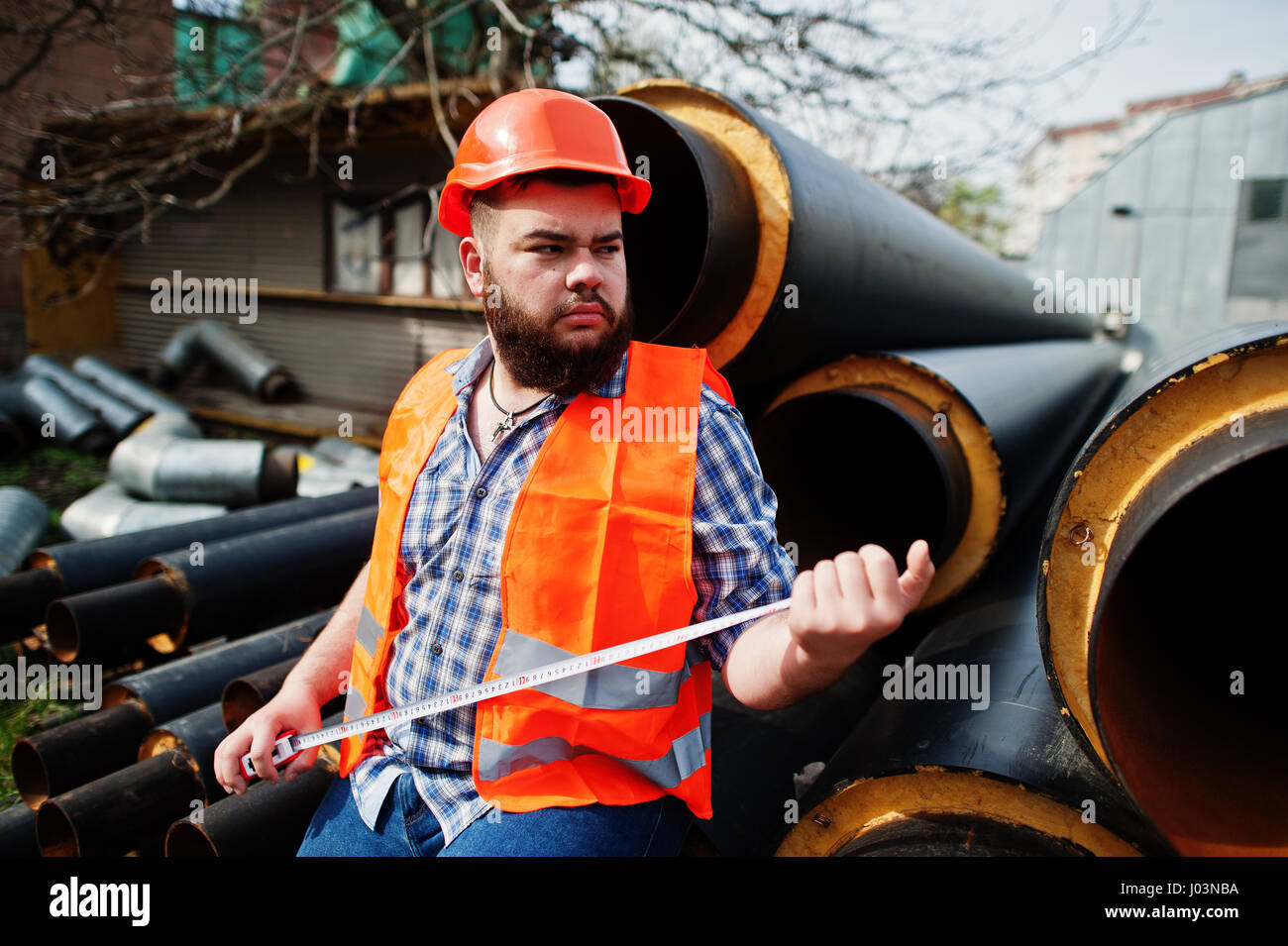 Brutal beard worker man suit construction worker in safety orange ...