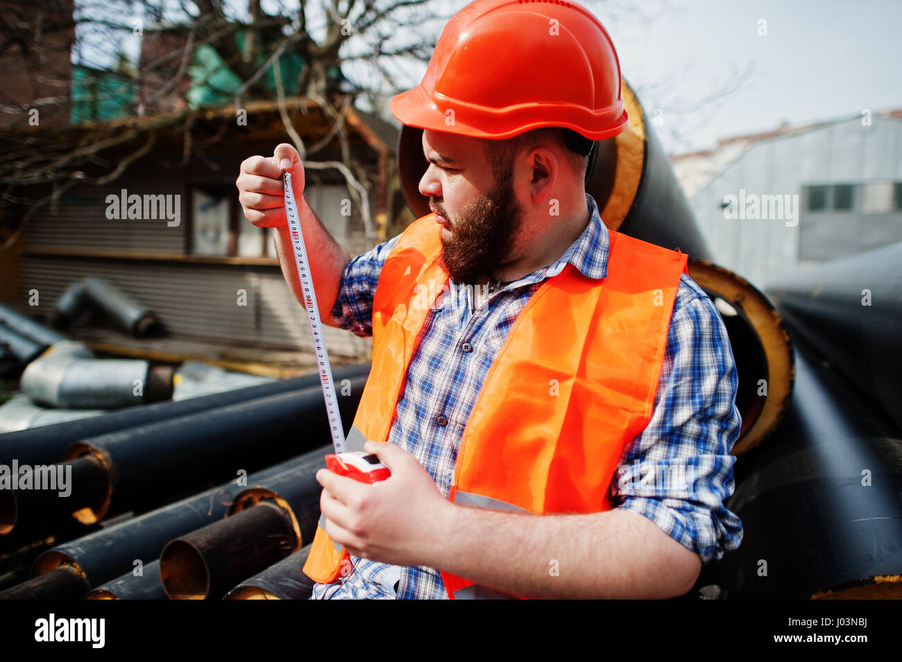 Brutal beard worker man suit construction worker in safety orange ...