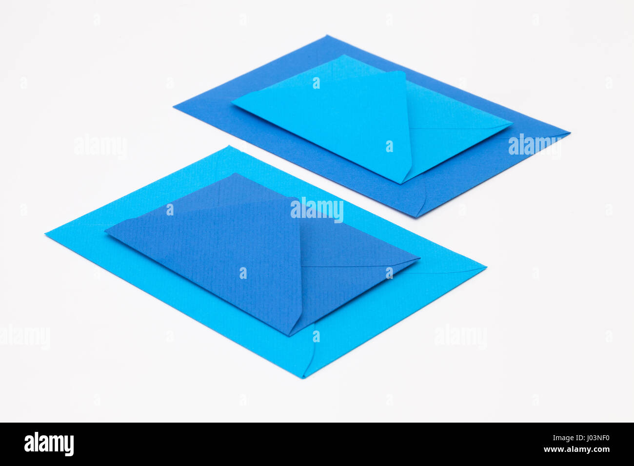 Jigsaw puzzle from big and small blue envelopes on the white table ...