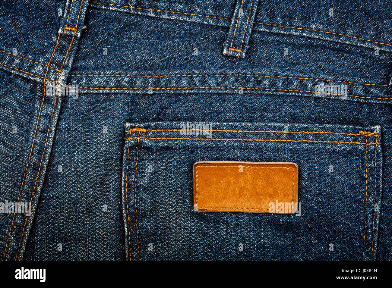 Blue jeans fabric with back pocket and a label background Stock Photo ...