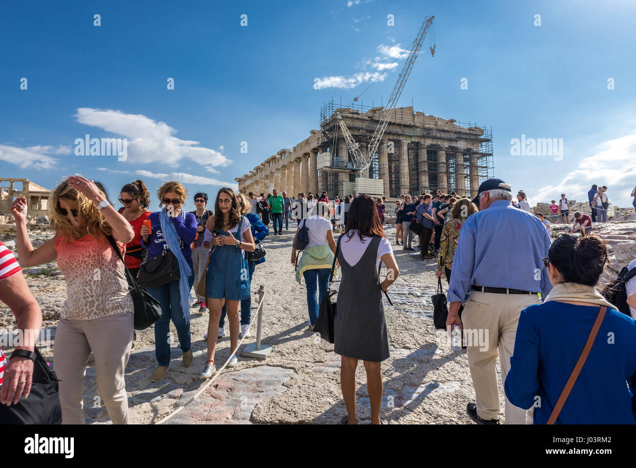 Tourists in front of Parthenon temple dedicated to the goddess Athena ...