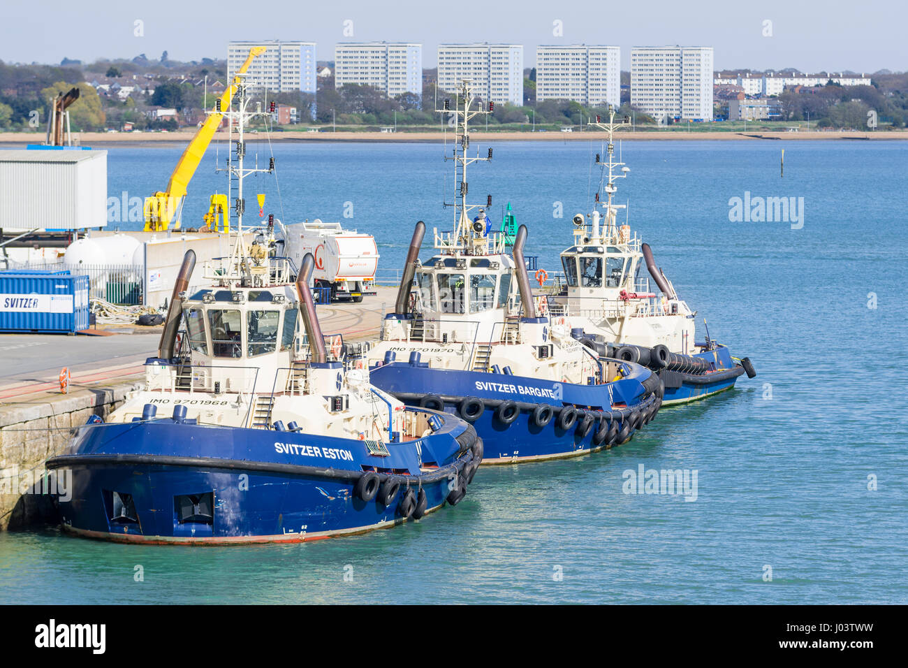 Tug boats at sea. 3 Svitzer tugboats moored in port in the Solent at ...