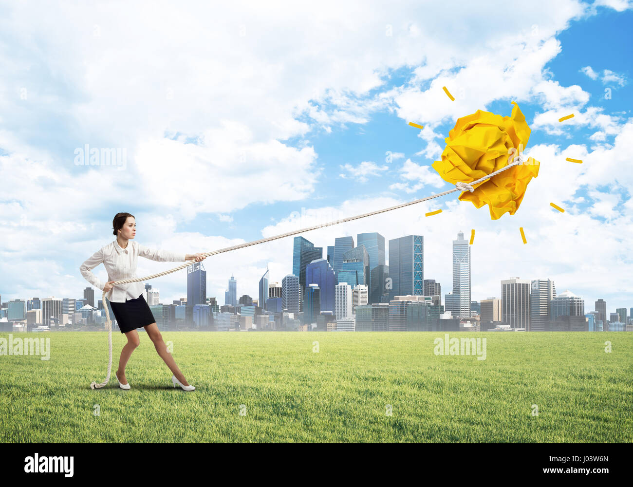 Businesswoman pulling paper ball with rope and making it raise up Stock ...
