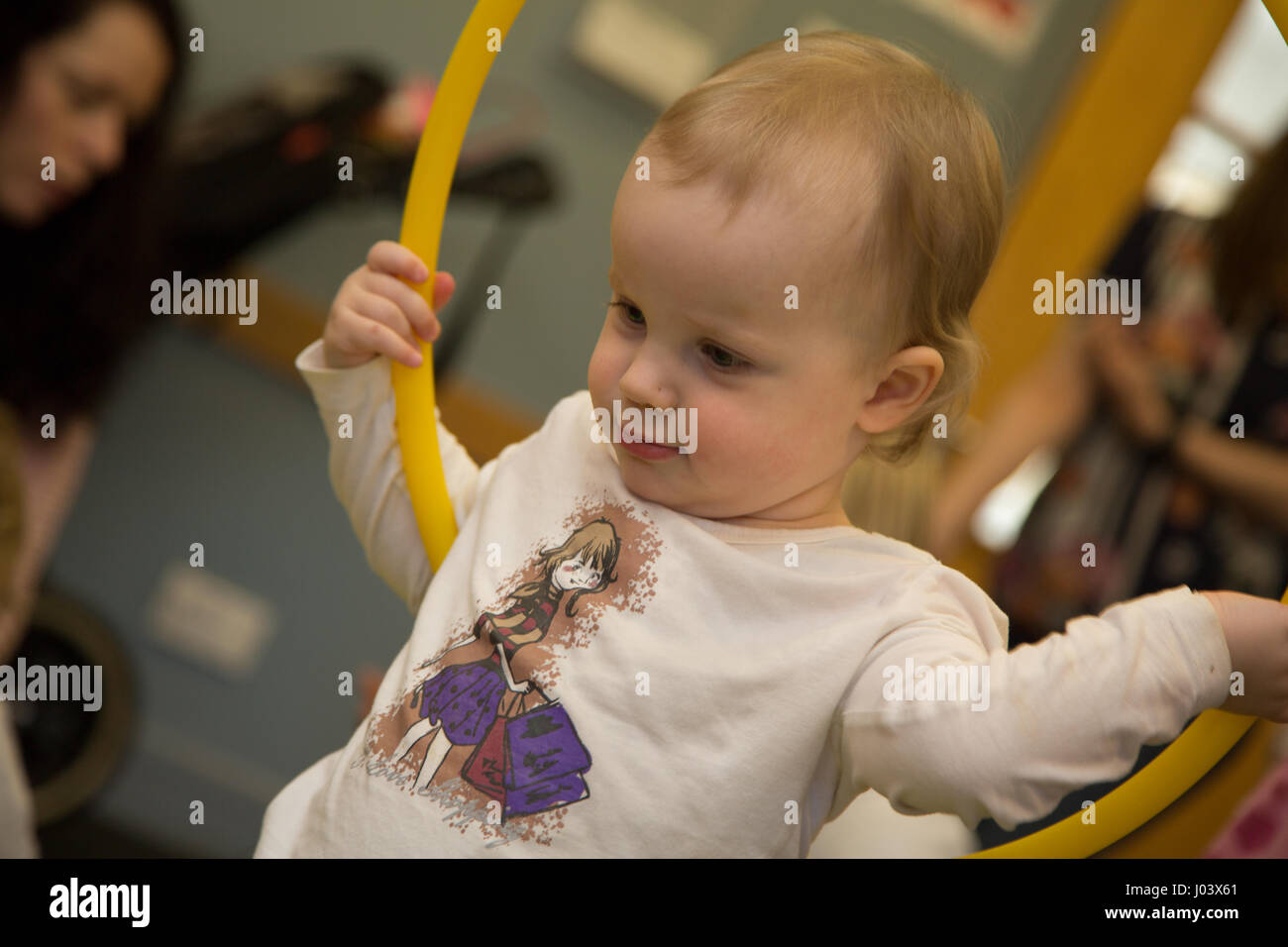 Toddler playing with hula hoop Stock Photo - Alamy