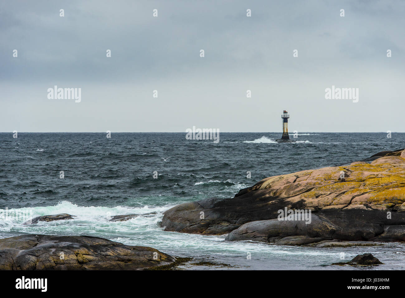 Windy sea hitting the rocks Stock Photo - Alamy