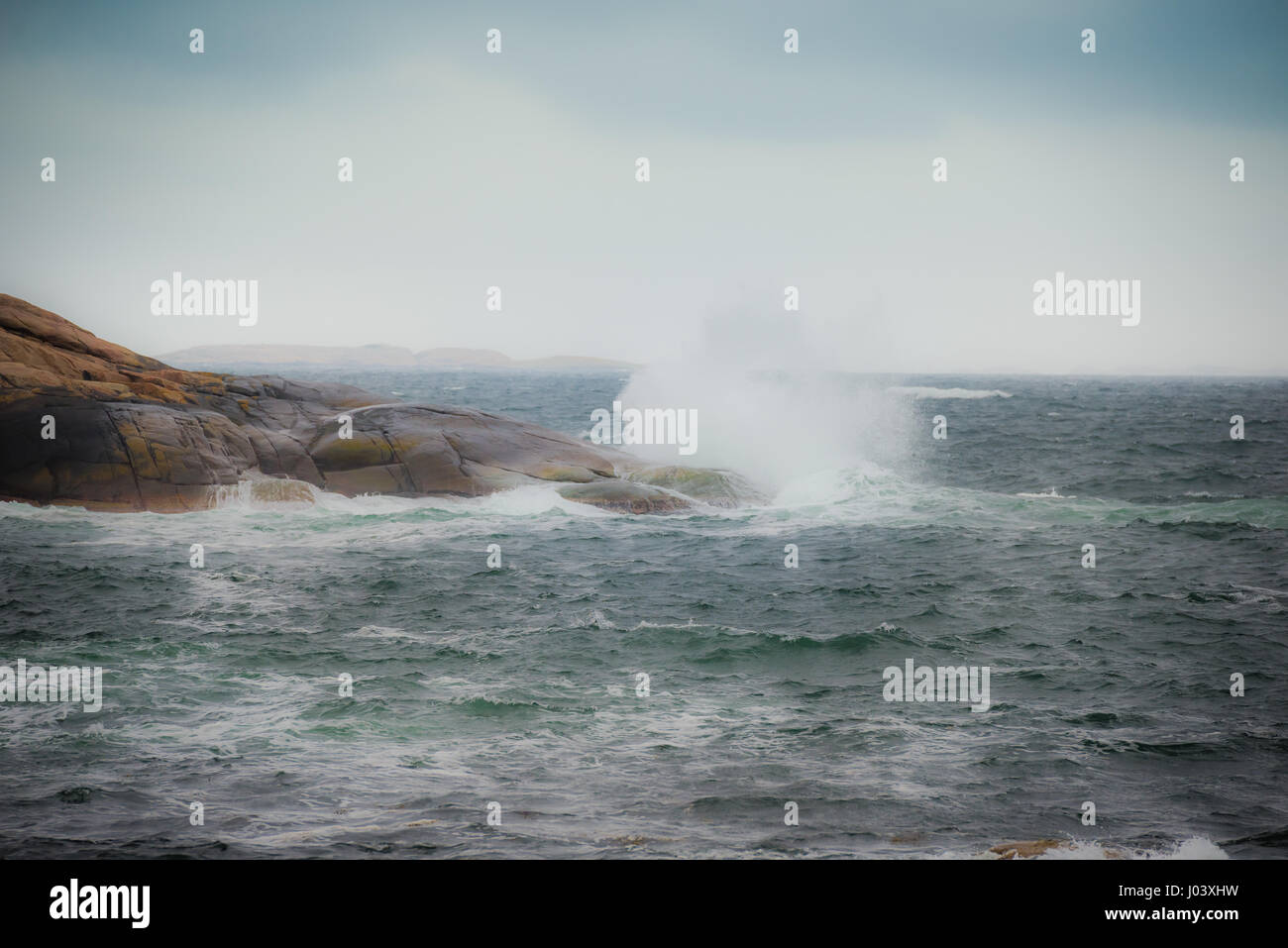 Windy sea hitting the rocks Stock Photo - Alamy