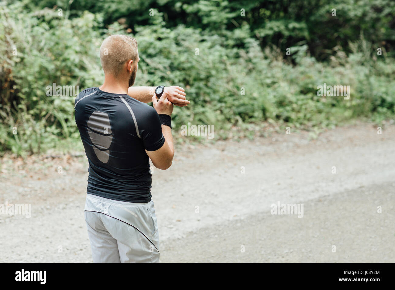 Rear view young man checking hi-res stock photography and images - Alamy