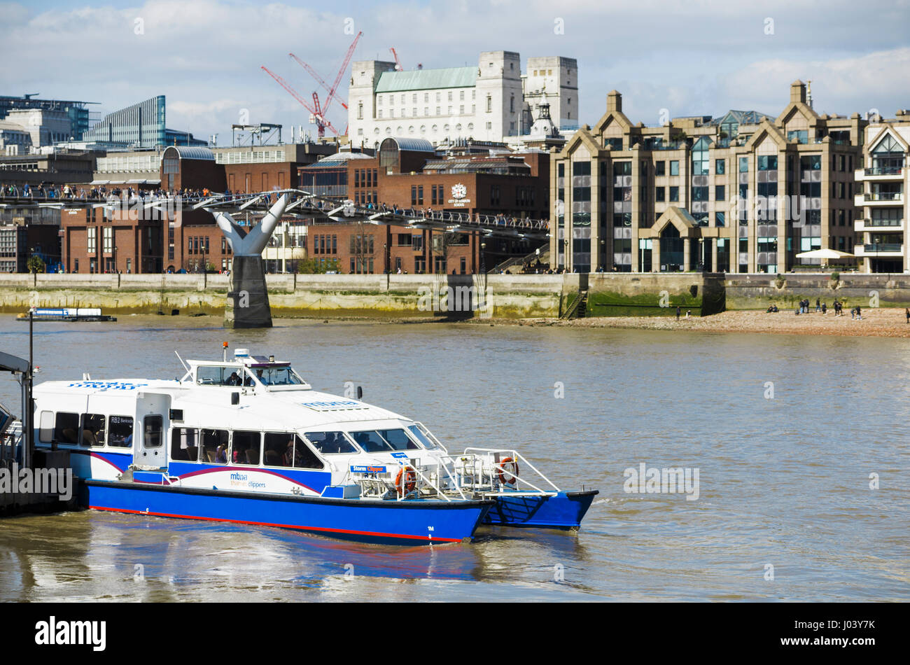 Blue and white Catamaran Thames Clipper boat forming part of the river ...