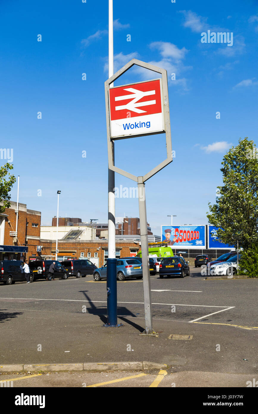 Crooked, leaning railway sign at Woking station, Woking, Surrey, south ...