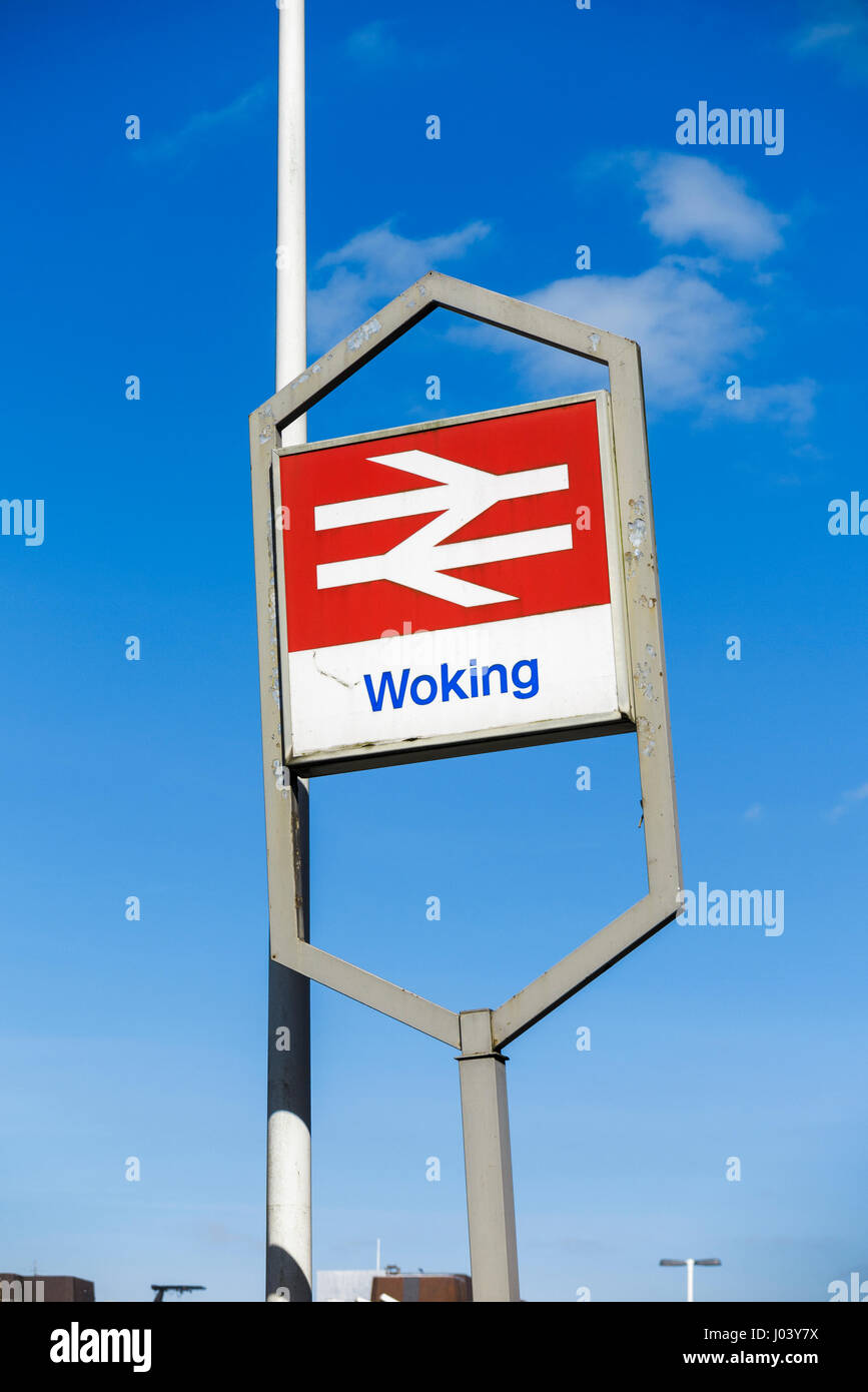 Crooked, leaning railway sign at Woking station, Woking, Surrey, south ...