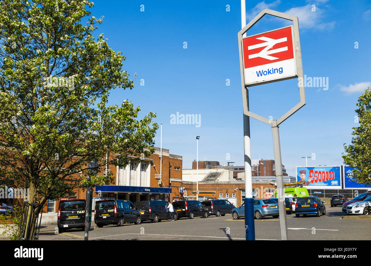 Crooked, leaning railway sign at Woking station, Woking, Surrey, south ...