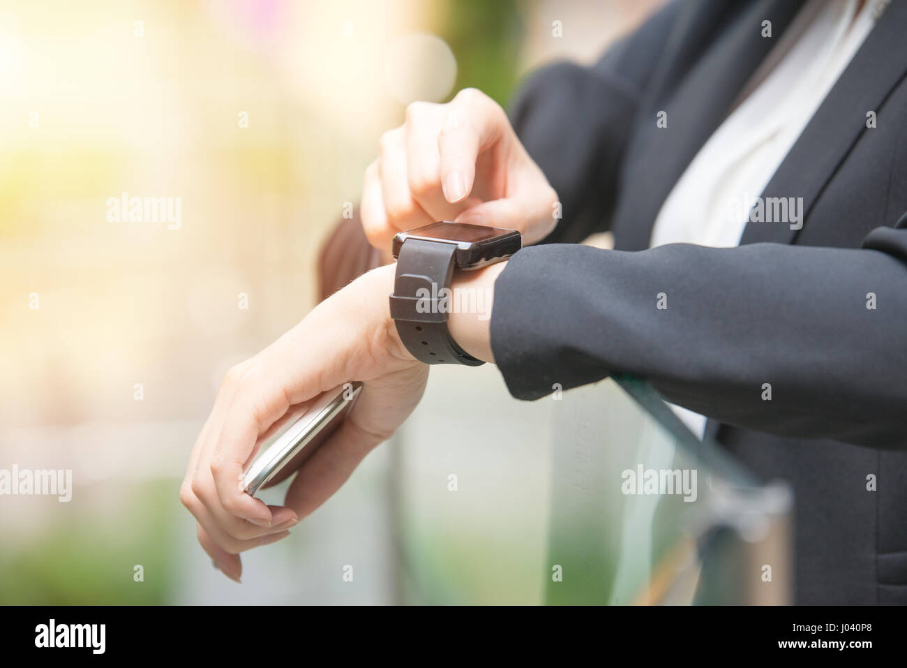 Woman checking clock office hi-res stock photography and images - Alamy