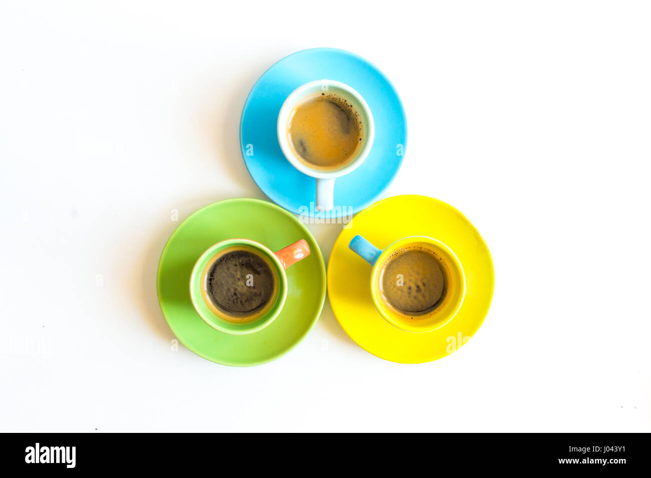 Three colorful coffee cups isolated on white background Stock Photo - Alamy