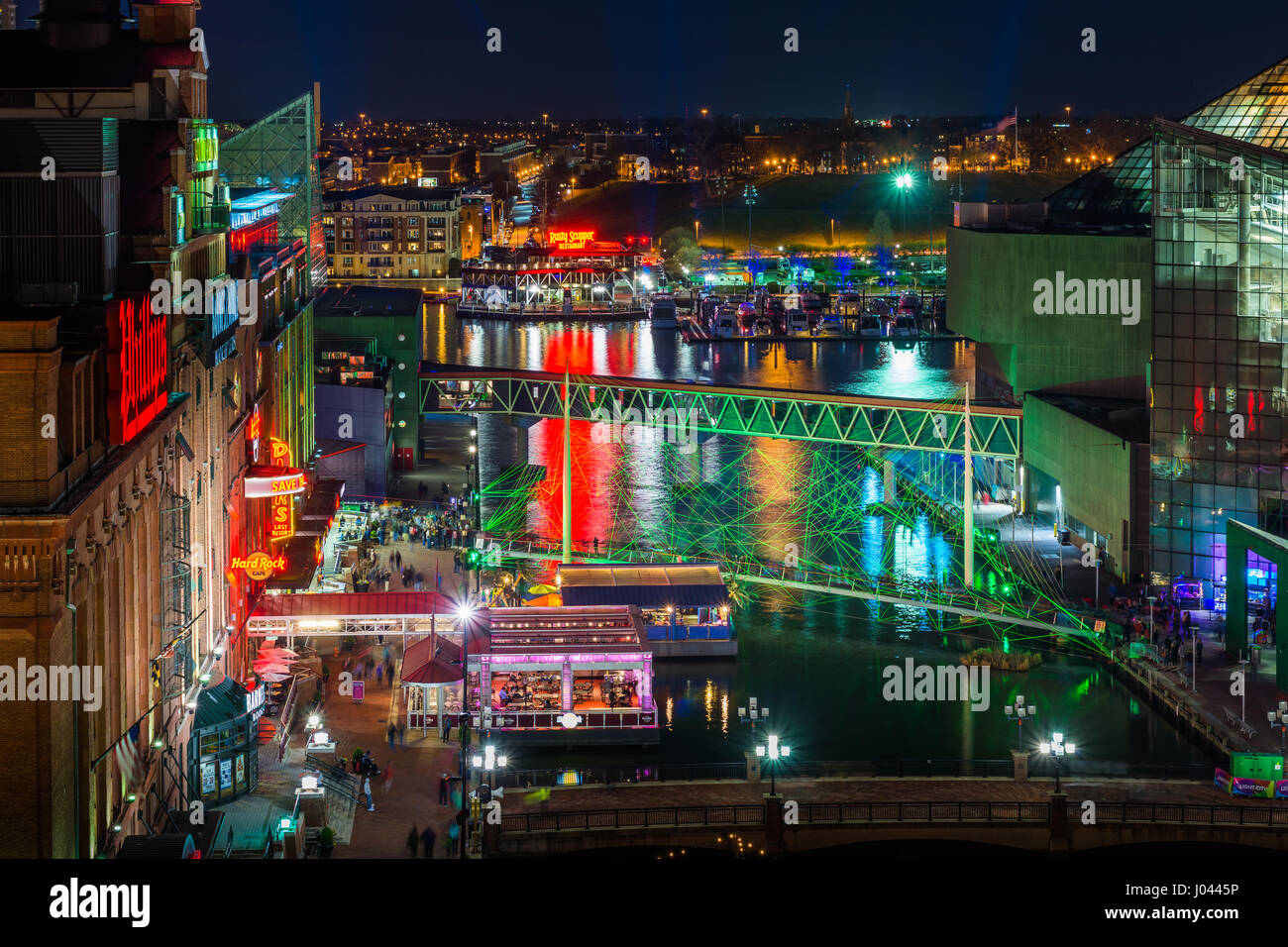 View of buildings and pedestrian bridges at the Inner Harbor at night ...