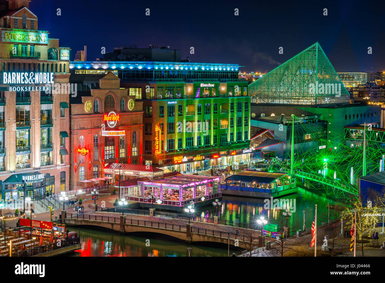 View of buildings and pedestrian bridges at the Inner Harbor at night ...
